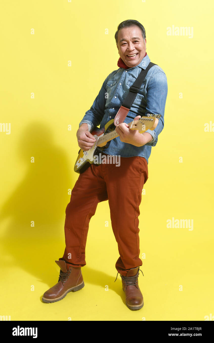 Happy old man playing the guitar Stock Photo - Alamy