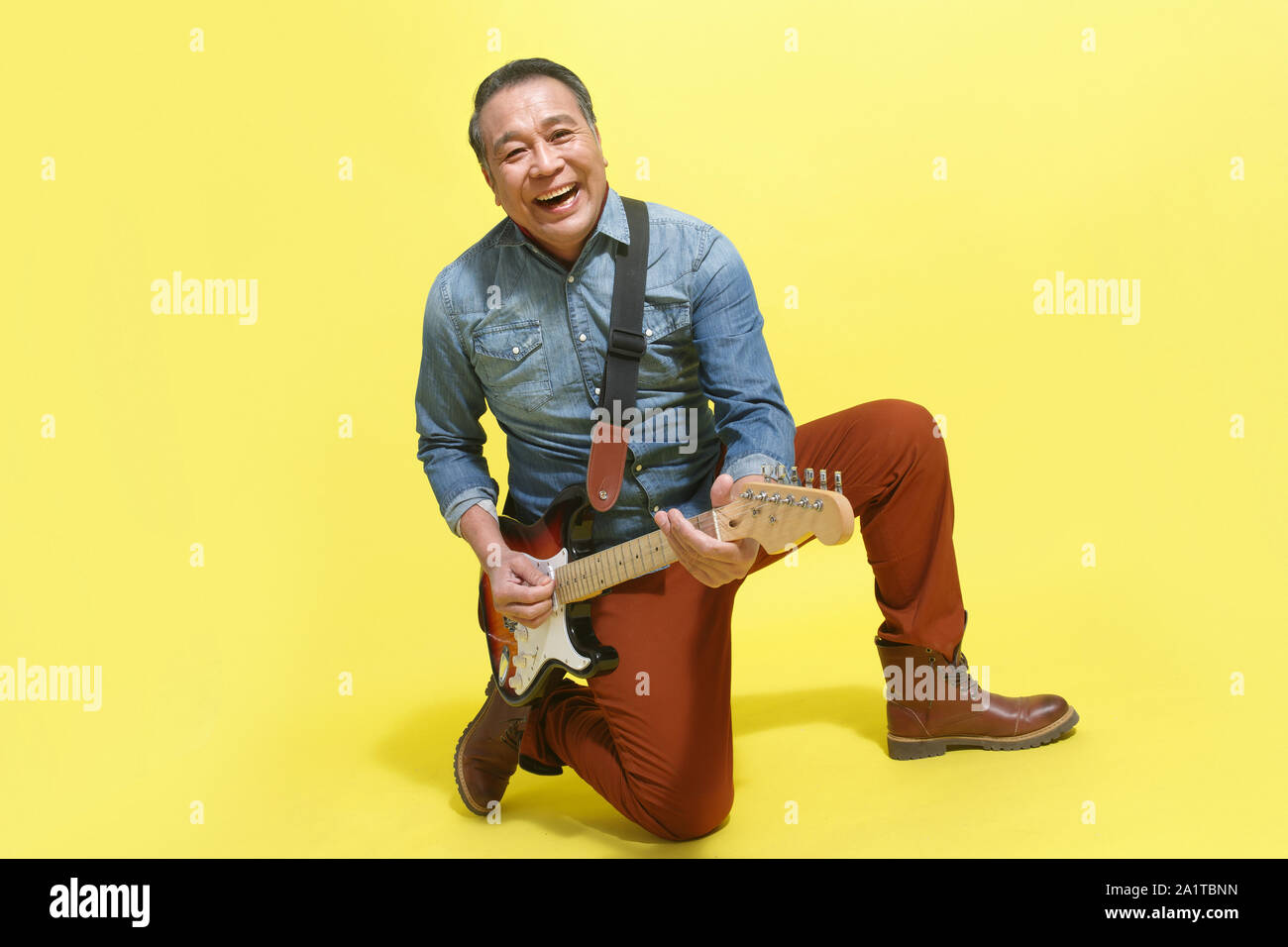 Happy old man playing the guitar Stock Photo - Alamy