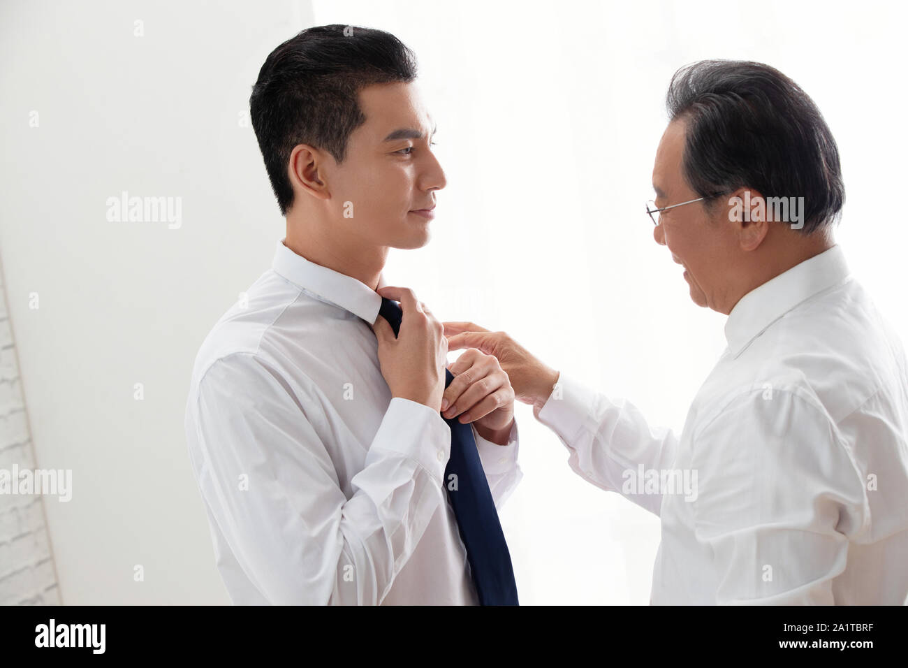 Father to son finishing clothes Stock Photo - Alamy