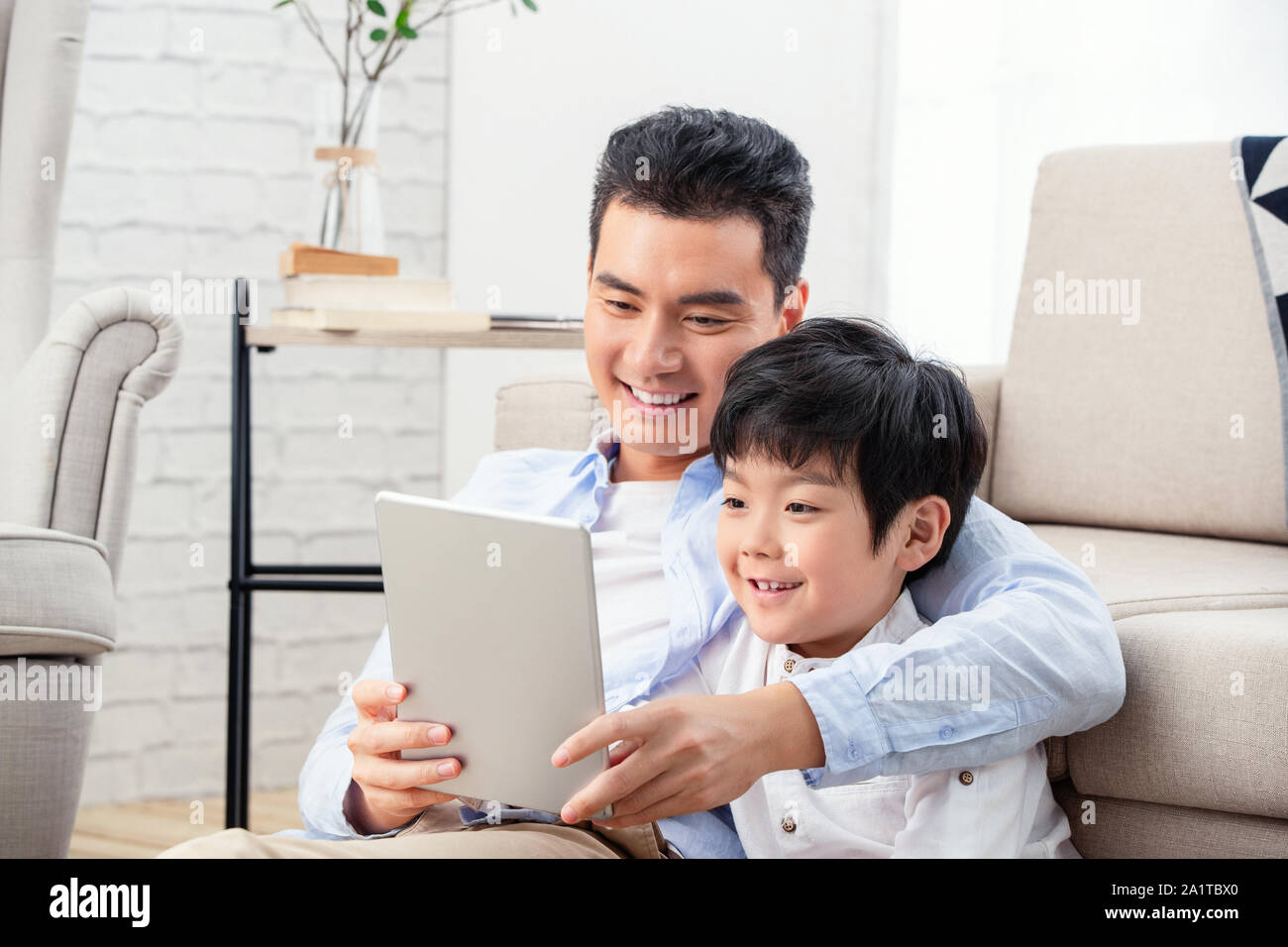 Happy father and son use the tablet Stock Photo - Alamy