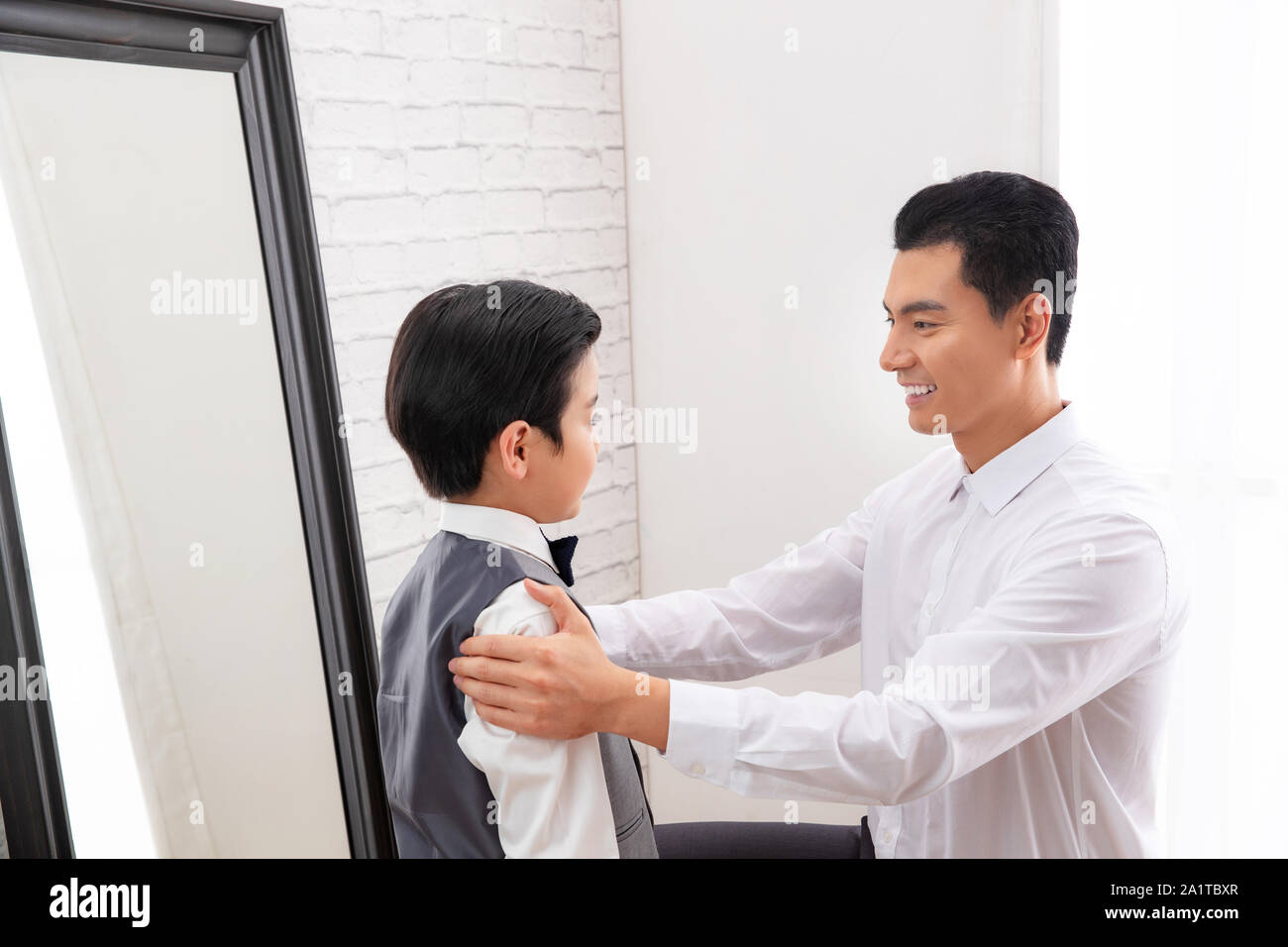 Father to son finishing clothes Stock Photo - Alamy
