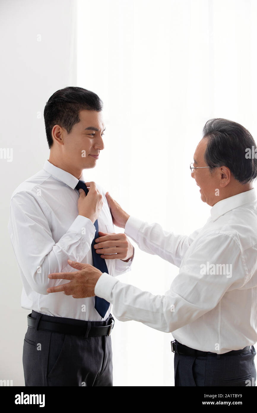 Father to son finishing clothes Stock Photo - Alamy