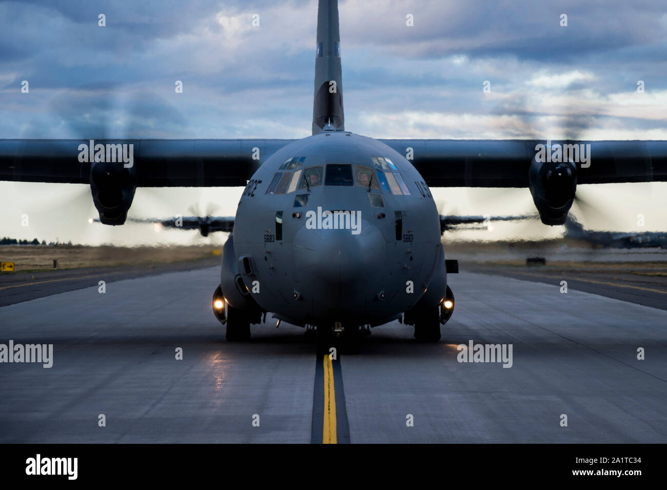 A formation of C-130 Hercules taxi down flight line in preparation for ...