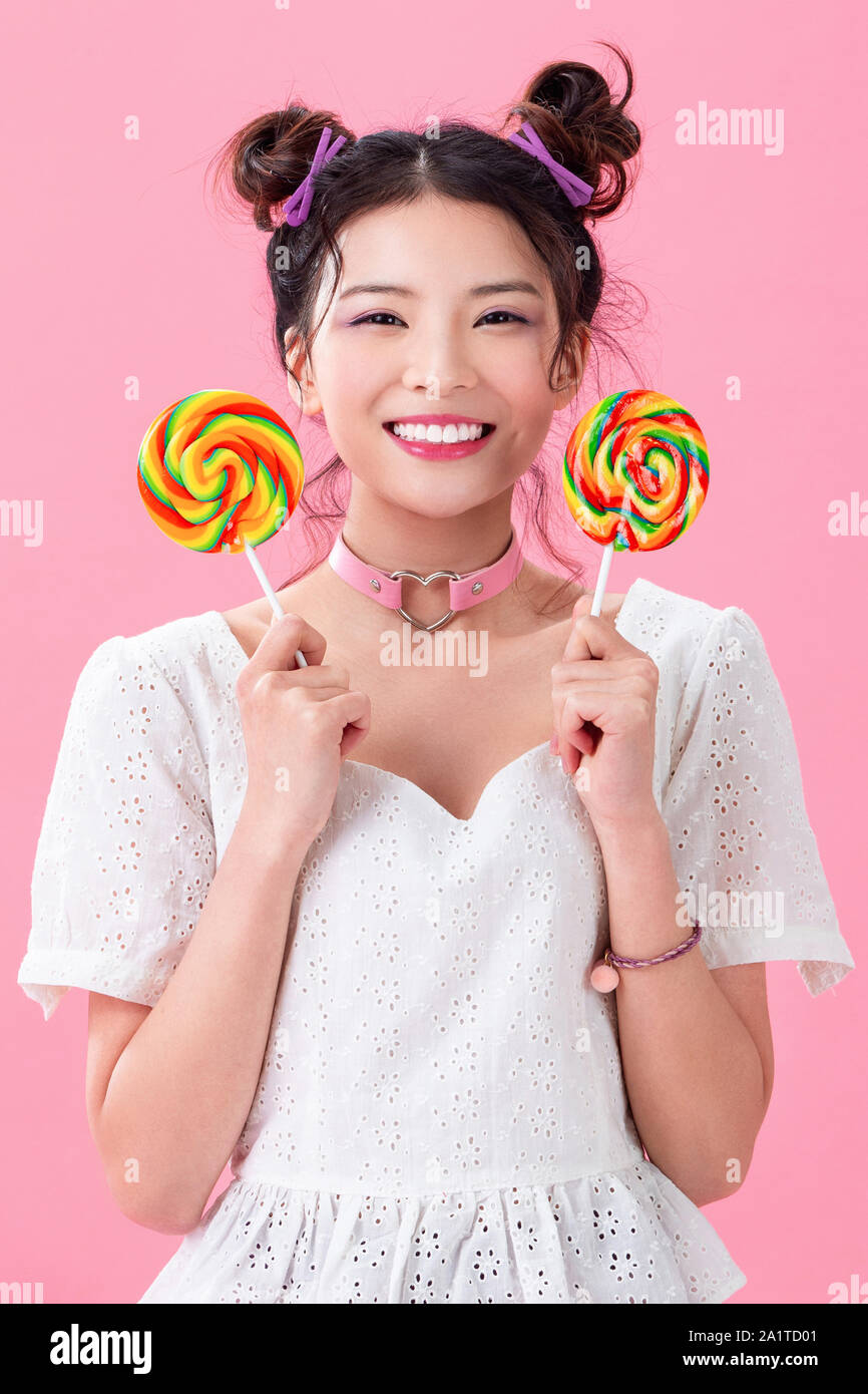 Happy girl with a sucker Stock Photo - Alamy