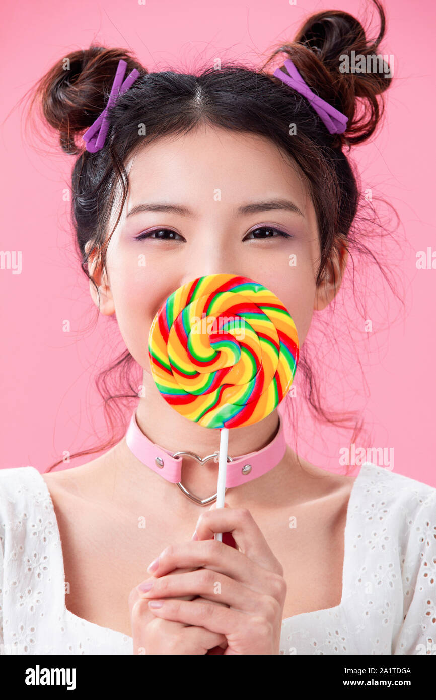 Happy girl with a sucker Stock Photo - Alamy