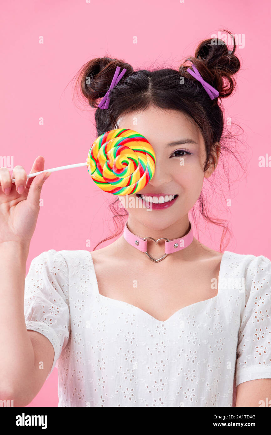 Happy girl with a sucker Stock Photo - Alamy