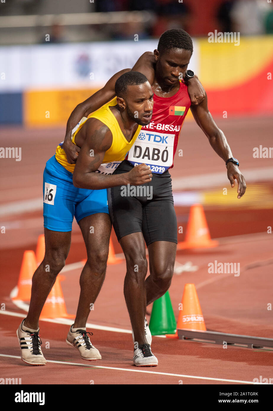 Braima Suncar Dabo of Guinea-Bissau helps Jonathan Busby of Aruba in ...