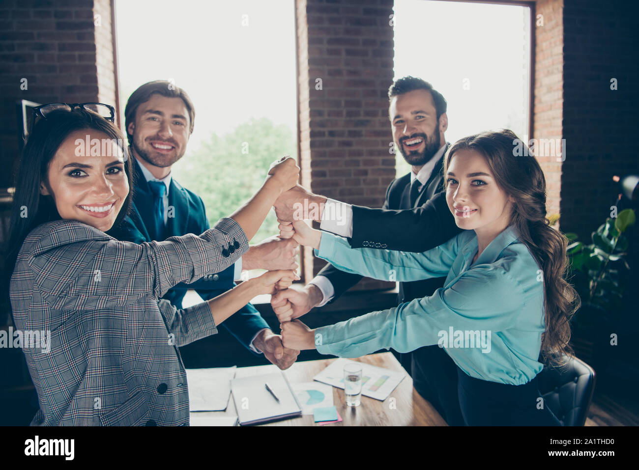 Four hands joined together hi-res stock photography and images - Alamy