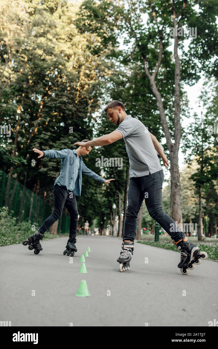 Roller skating, two skaters in protection rolling Stock Photo - Alamy