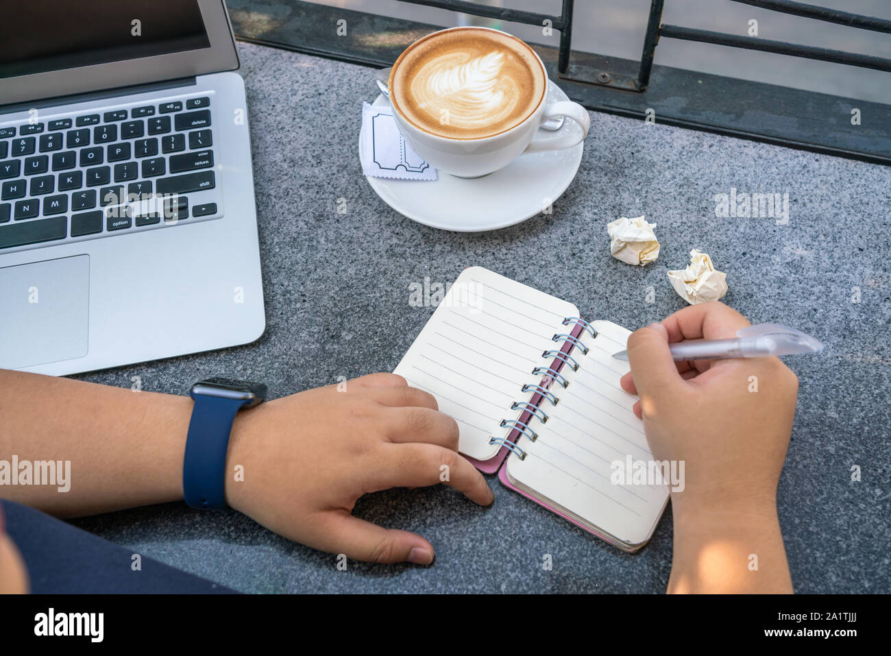 Woman writing notes next to laptop and cup of hot cappuccino Stock ...