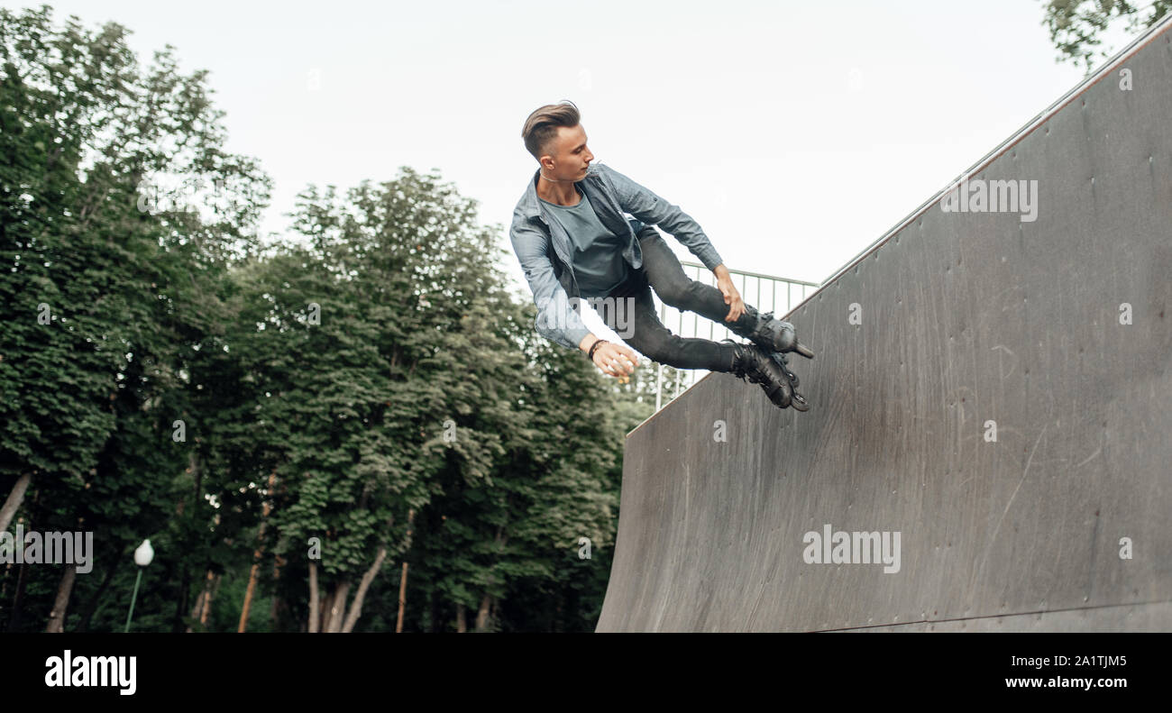 Roller skating, young skater rolling off the ramp Stock Photo - Alamy