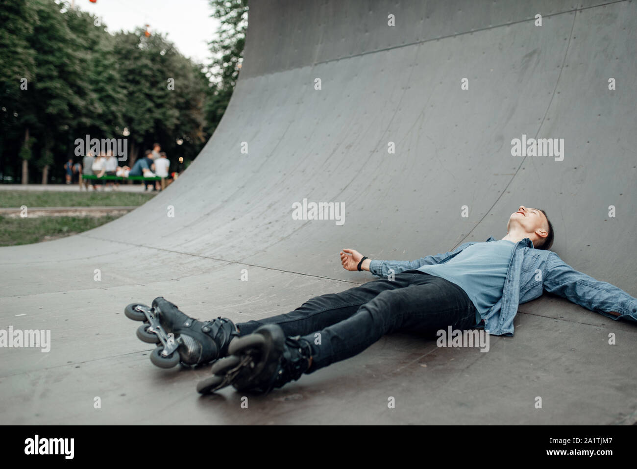 Roller skating, male skater lying on the ramp Stock Photo - Alamy