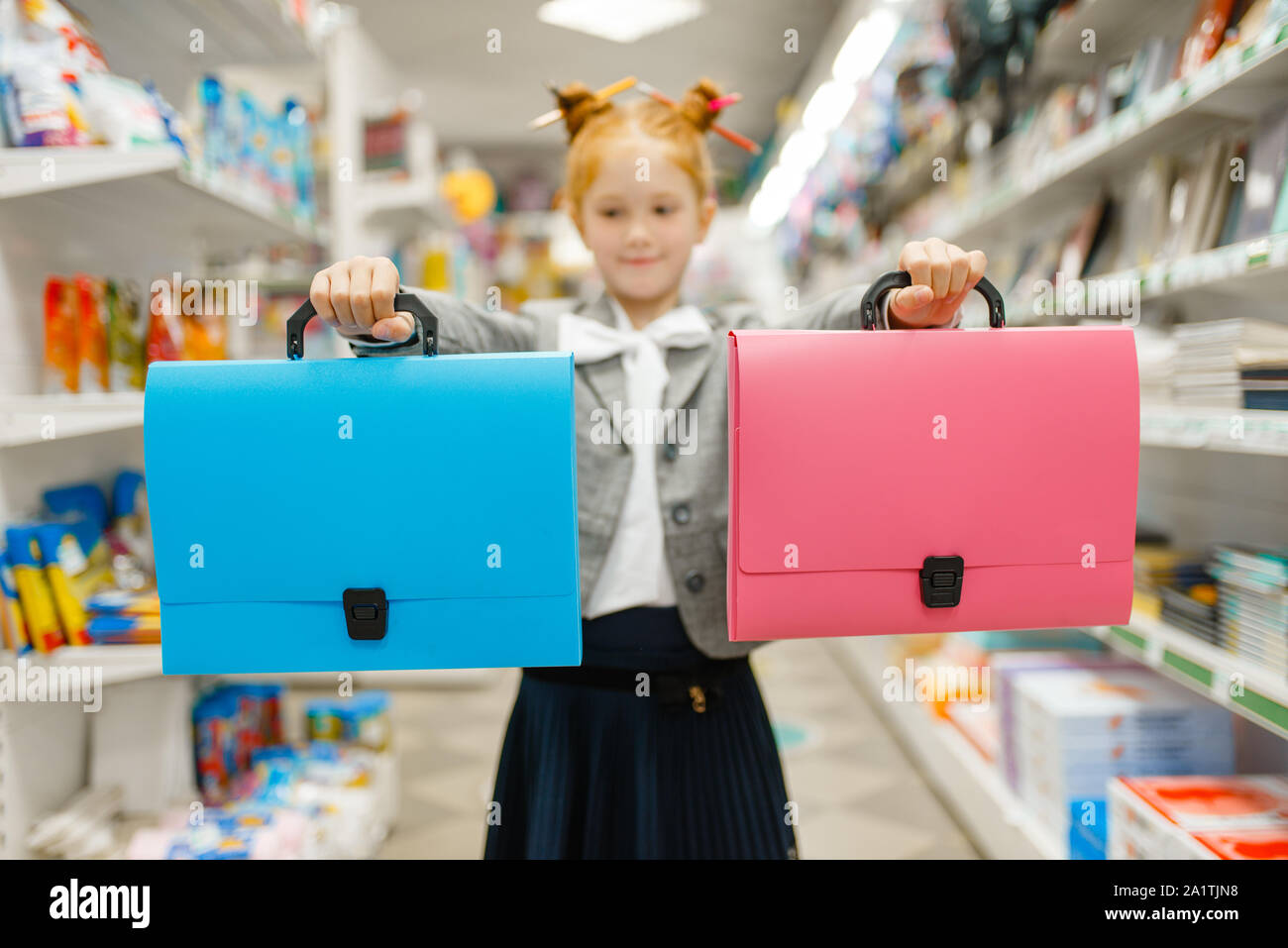 School girl with two folders in stationery store Stock Photo - Alamy