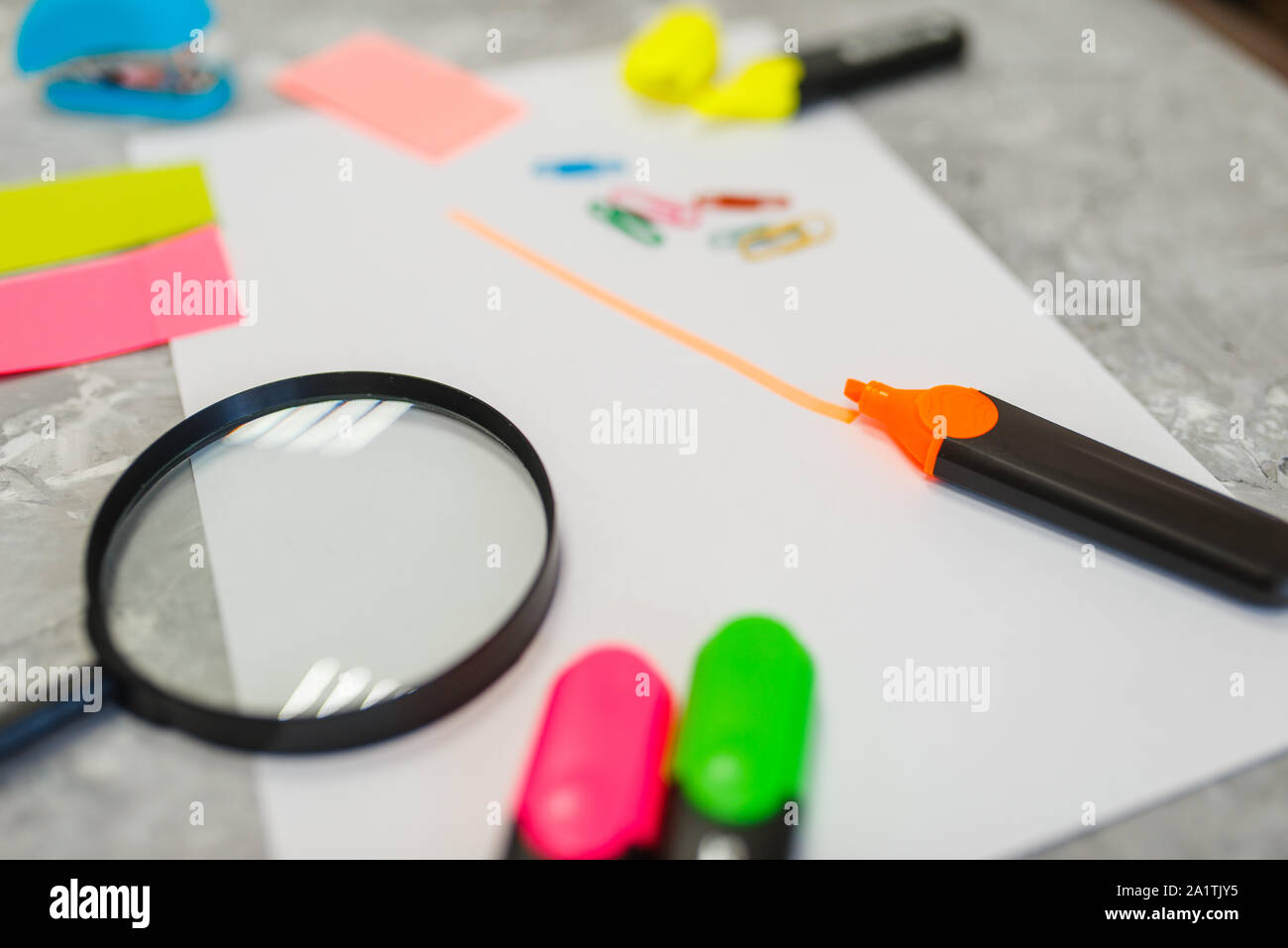 Magnifier and colorful markers in stationery store Stock Photo - Alamy
