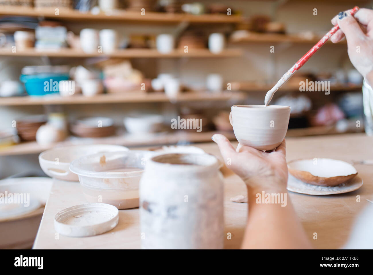 Female potter paints pot hi-res stock photography and images - Alamy