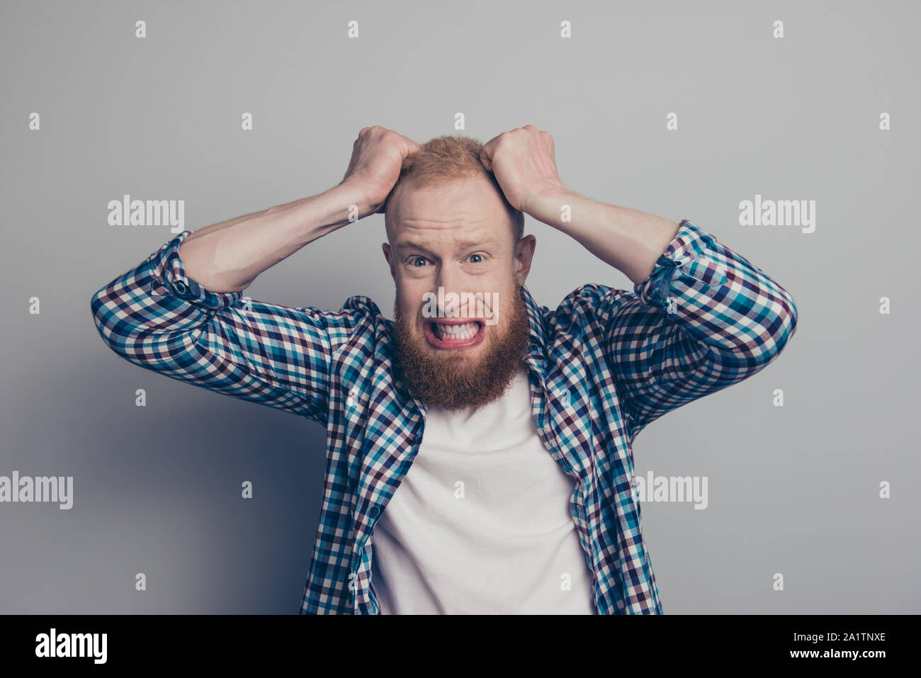 Portrait photo of scared man hold hands on head make scared face ...