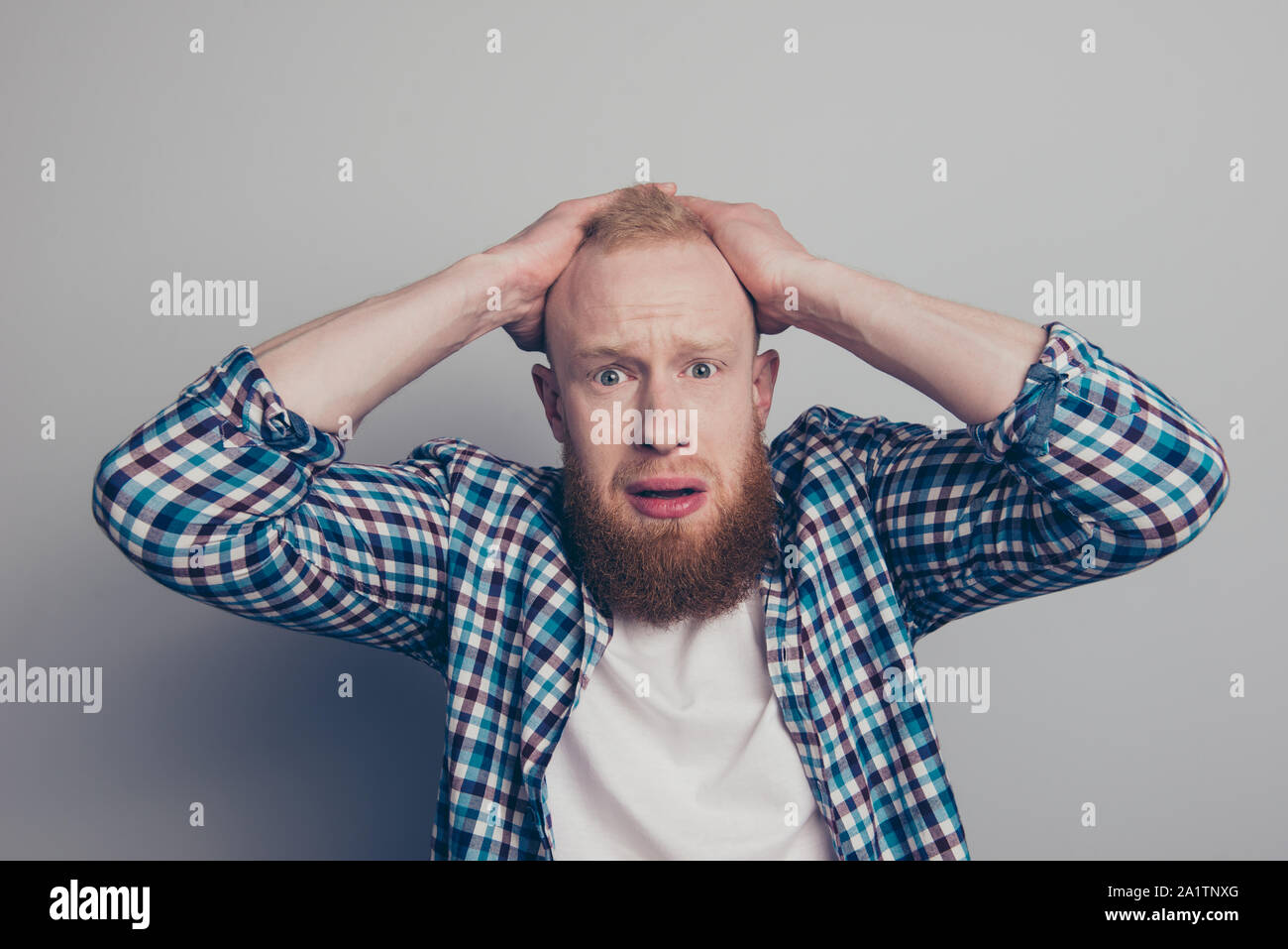 Close up photo portrait of scared moody man hold hands on head look at ...