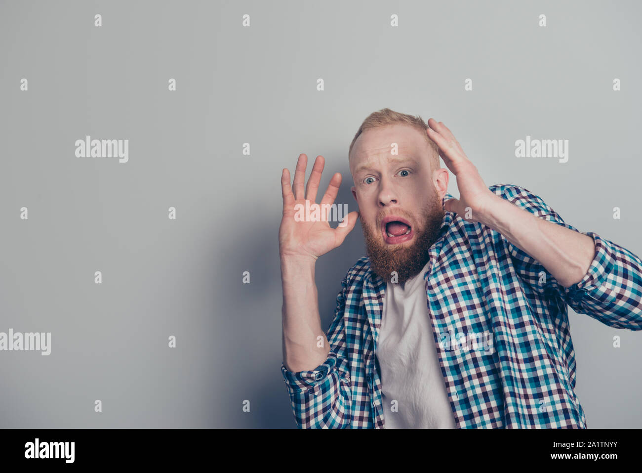 Confused person man in casual checkered shirt step back raised hands up ...