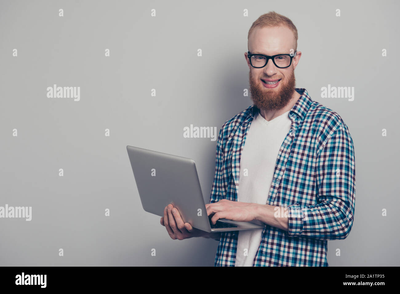 Portrait of nice cool man look at camera stand isolated on light gray ...