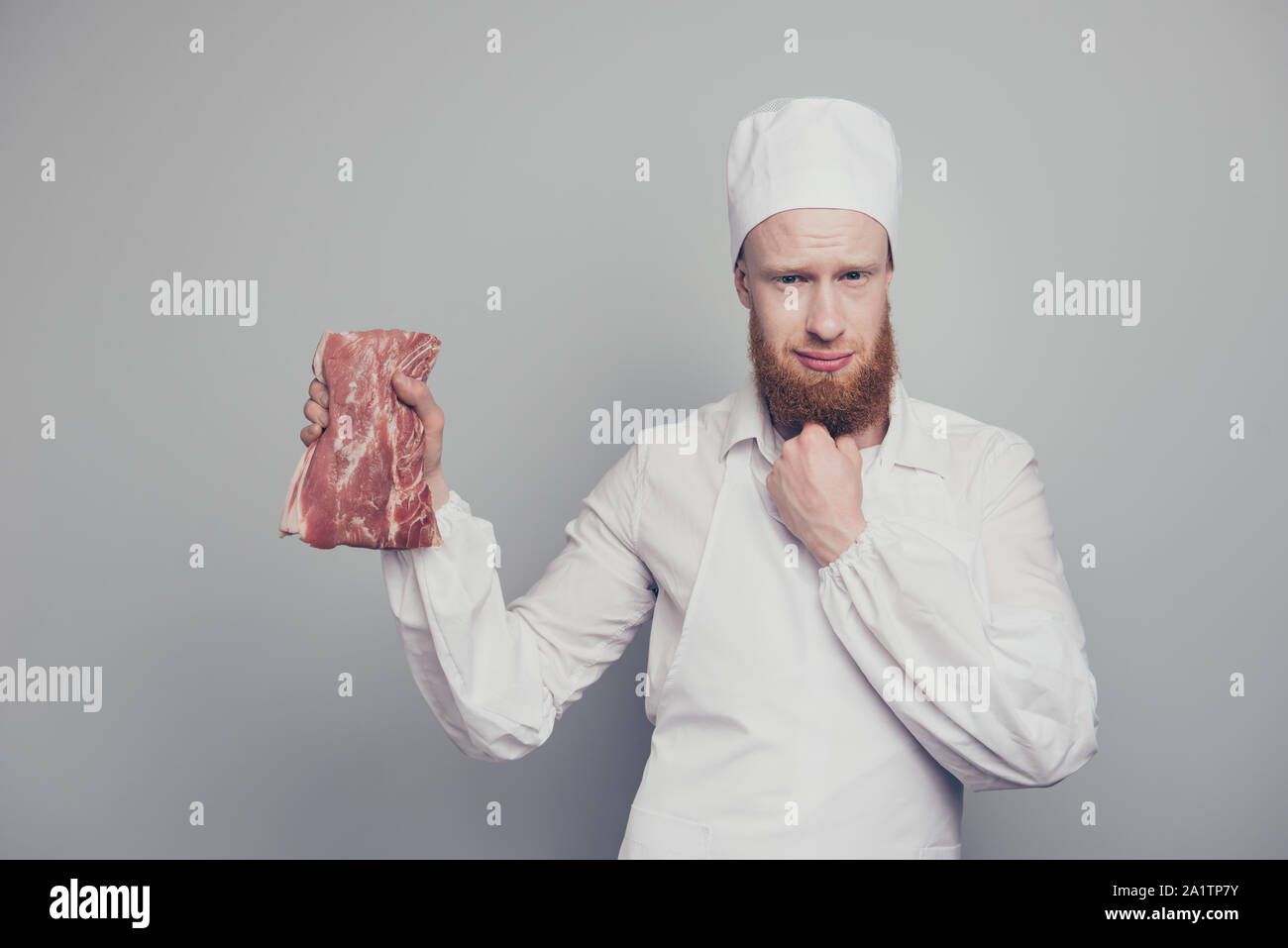 Portrait of he nice minded attractive handsome butcher guy holding ...