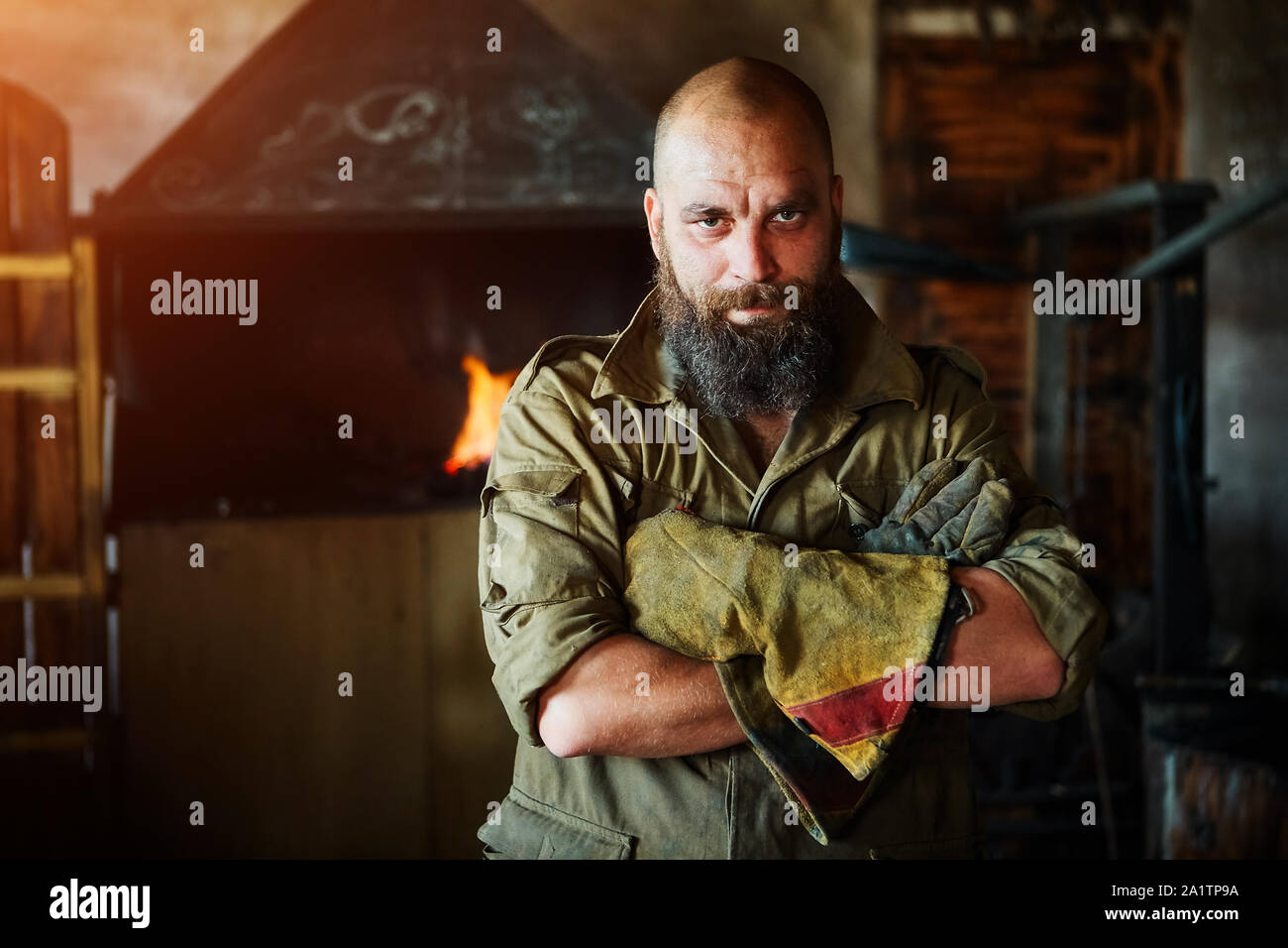 Portrait of a brutal, confident blacksmith, a man with a beard ...