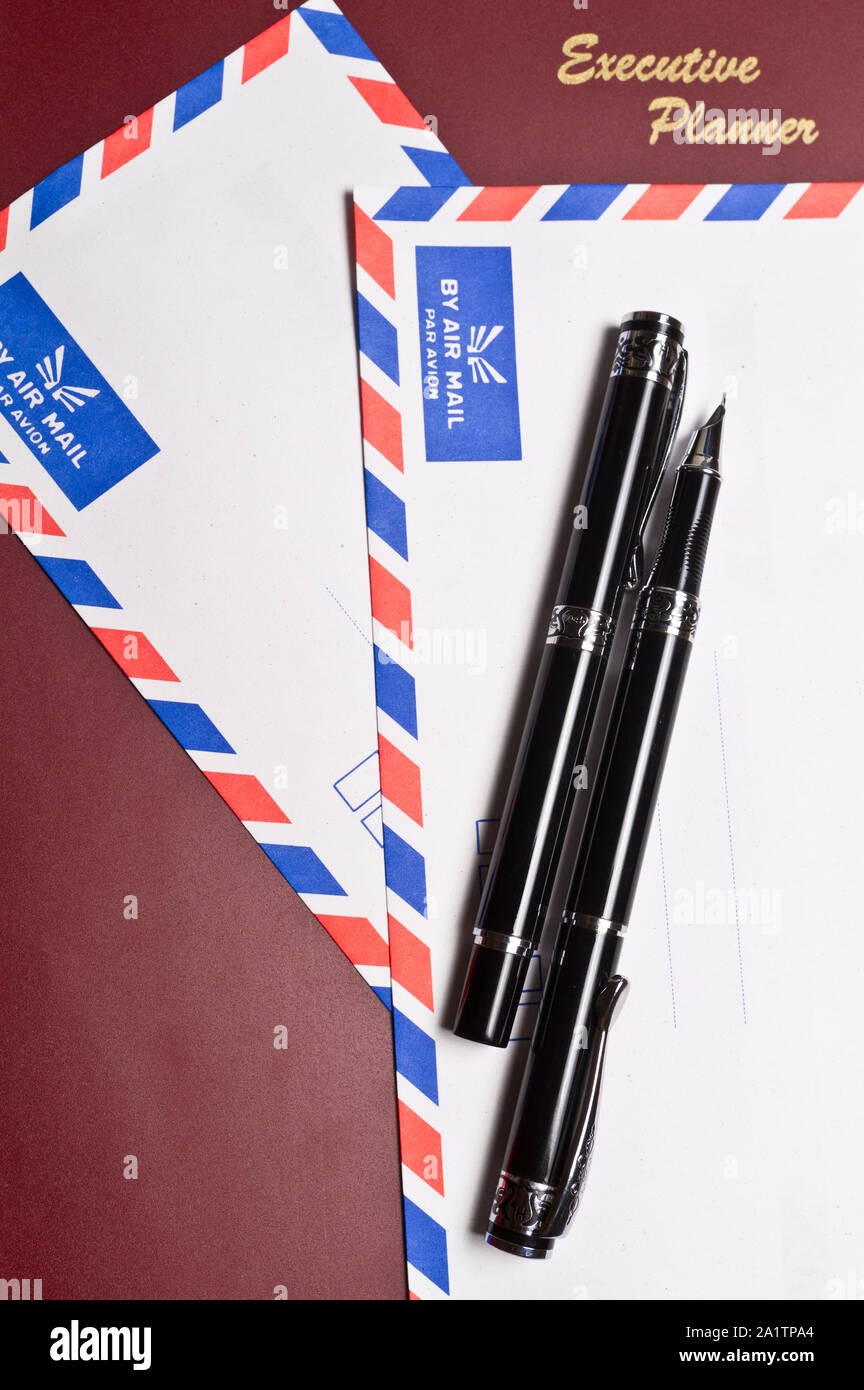executive planner with two white by air mail envelopes in portrait ...