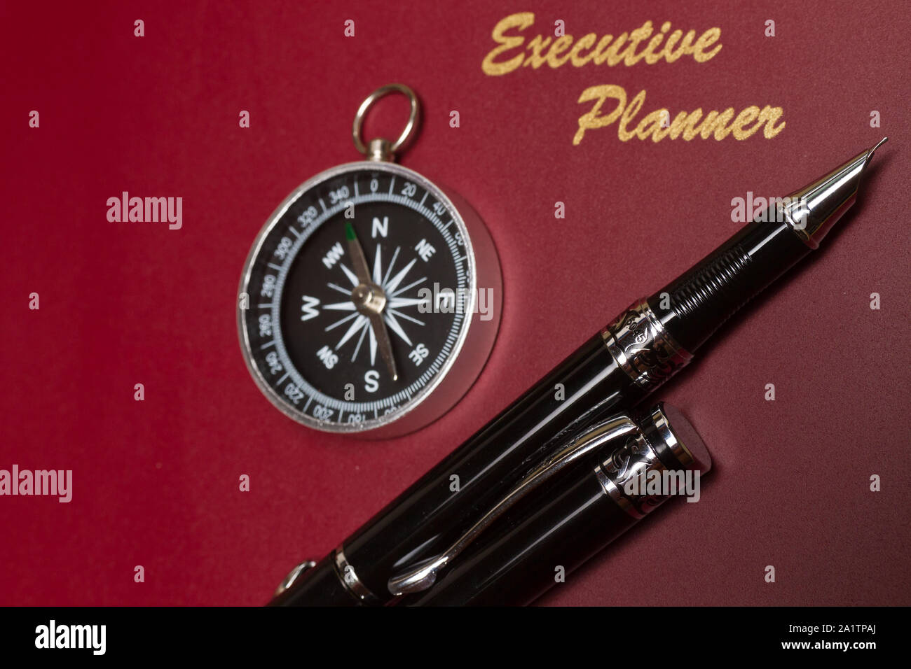 angled view of a dark red executive planner with simple compass and ...
