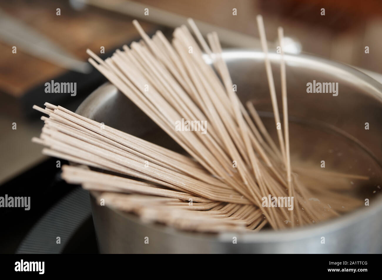 Buckwheat noodles being cooked on induction stove Stock Photo - Alamy