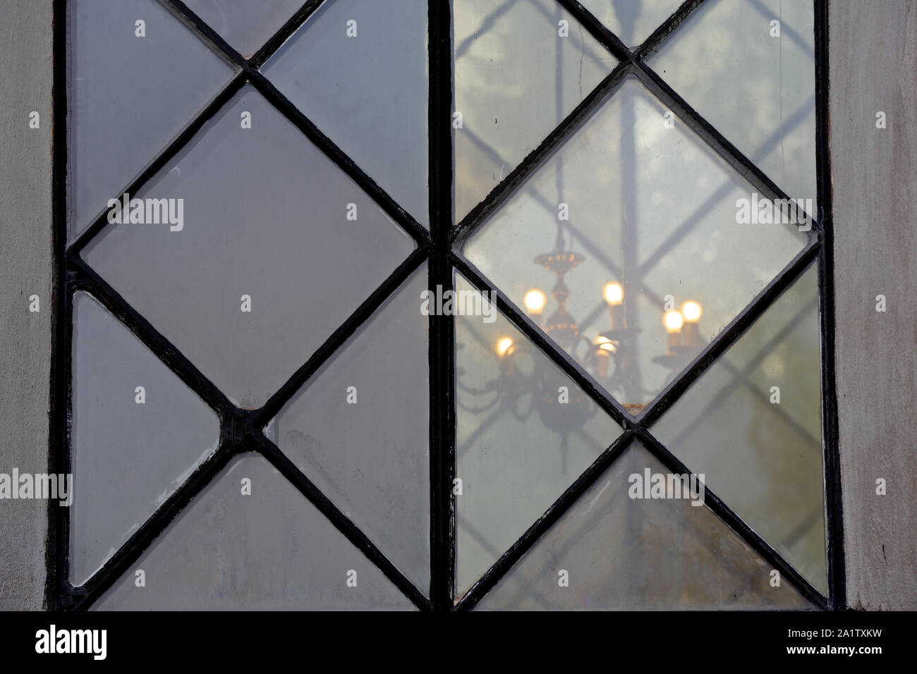 A part of a church glass window with chandelier lightning inside Stock ...