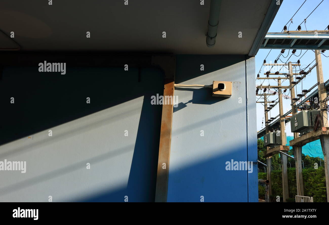 Closeup of old security camera installed on the wall under sunlight in ...