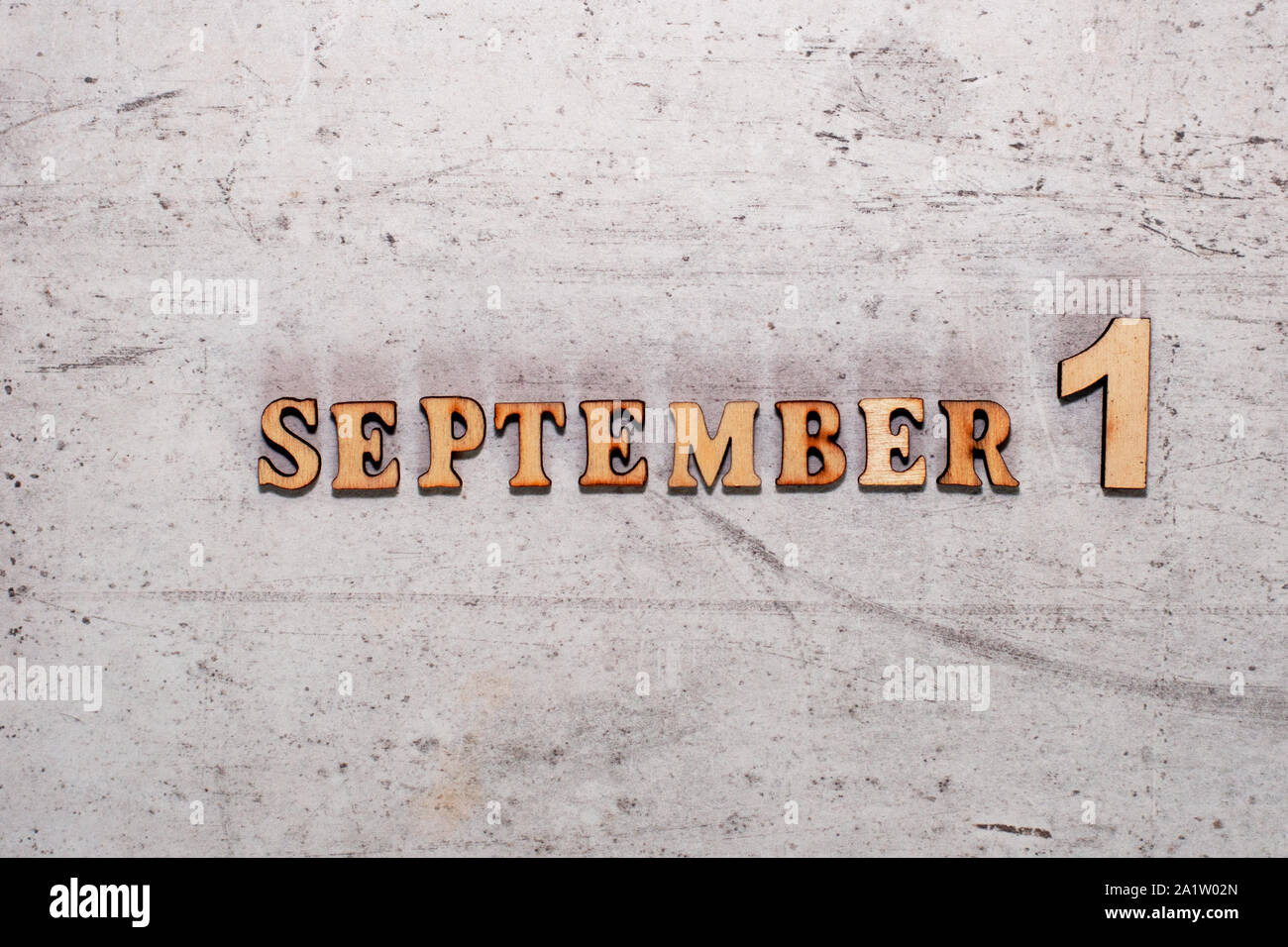 The word September 1 laid out in wooden letters on a light background ...