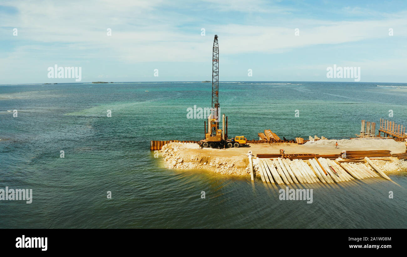 Pile driving is installing concrete pile. Heavy construction equipment ...