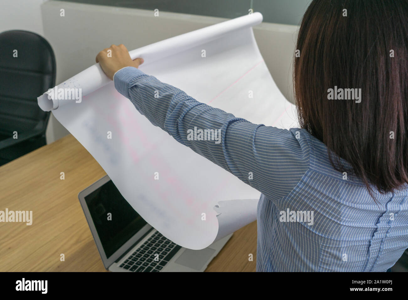 Close up photo of female hand holding project drawing paper Stock Photo ...