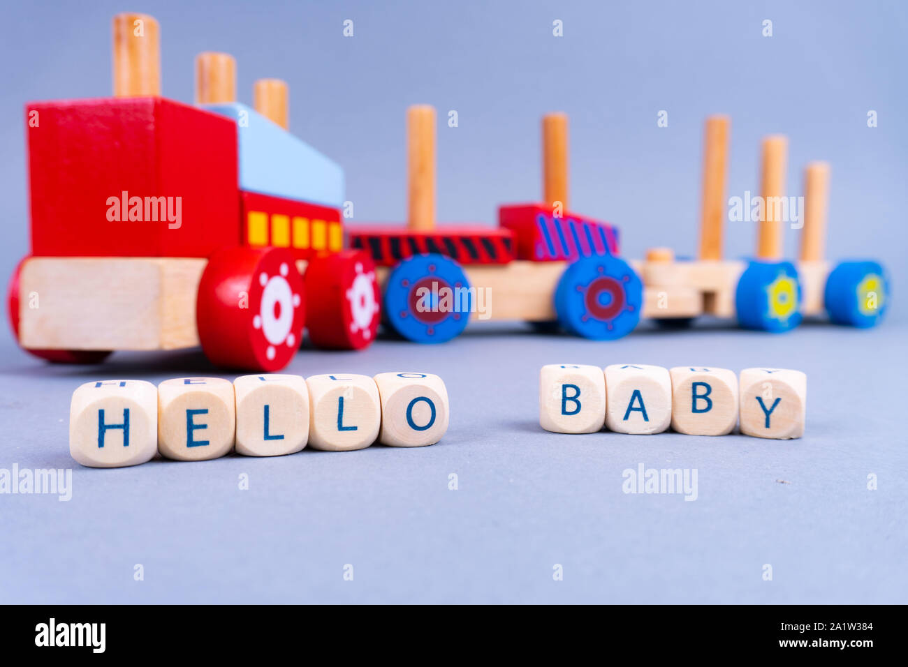 Letters in the front saying "Hello Baby", a colorful wooden train in ...