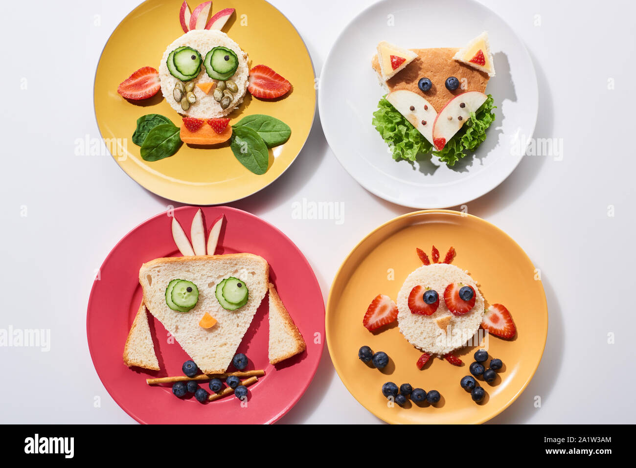 top view of plates with fancy animals made of food for childrens ...