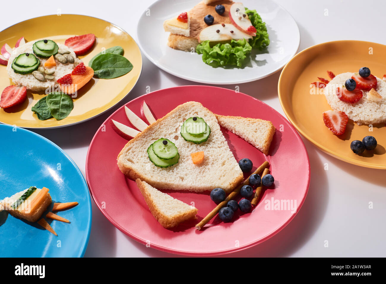 plates with fancy animals made of food for childrens breakfast on white ...