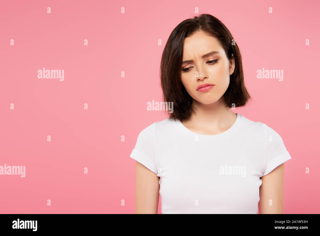 beautiful sad girl isolated on pink Stock Photo - Alamy