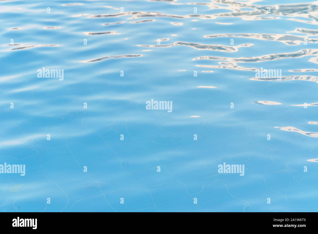 Background of water in blue swimming pool, water surface with sun ...