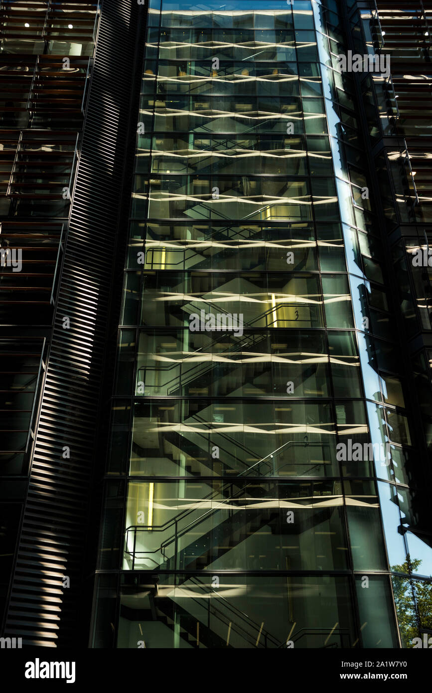 Reflections in the glass front of a modern high rise, glass and steel ...