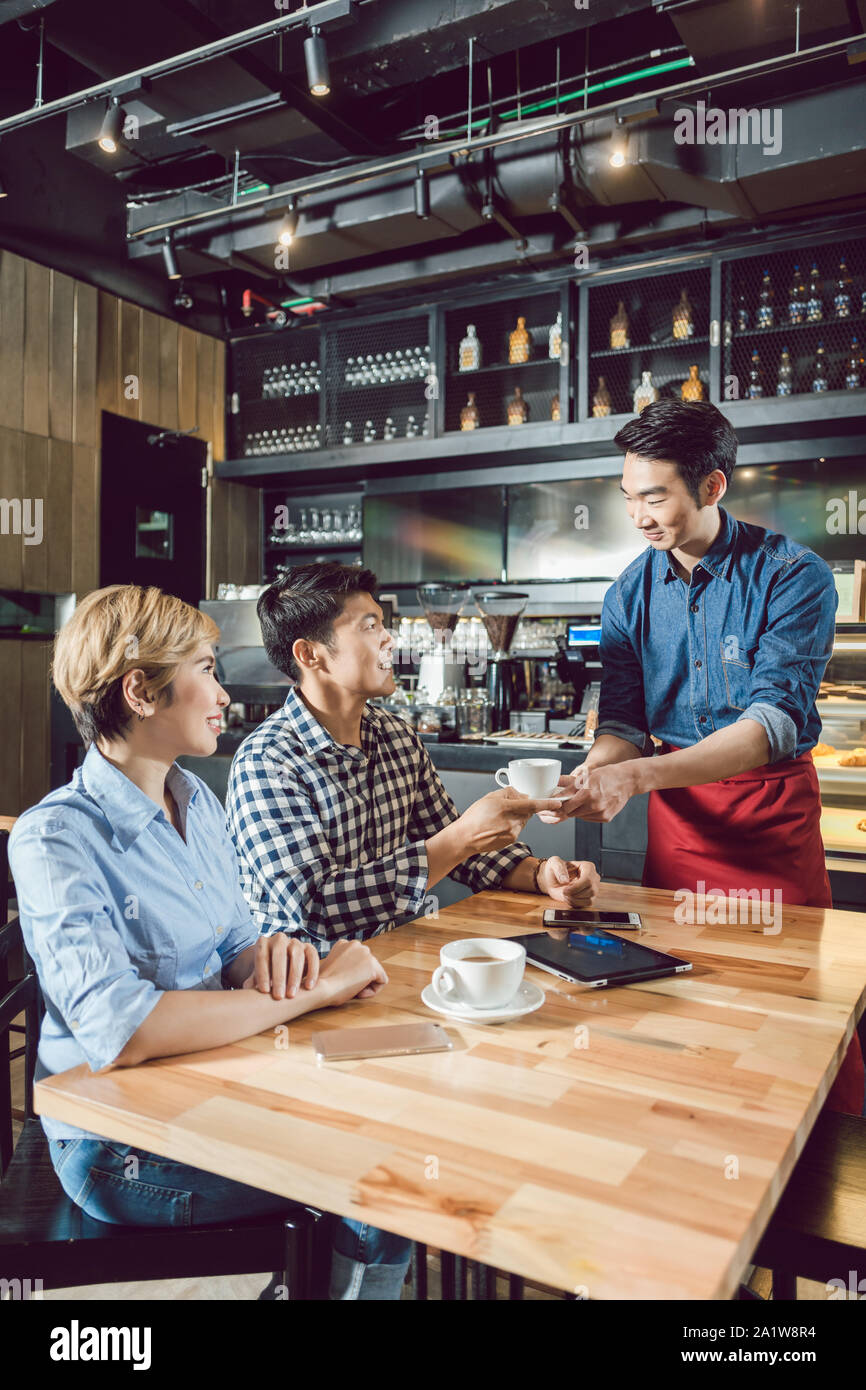 Young waiter worker cafeteria hi-res stock photography and images - Alamy