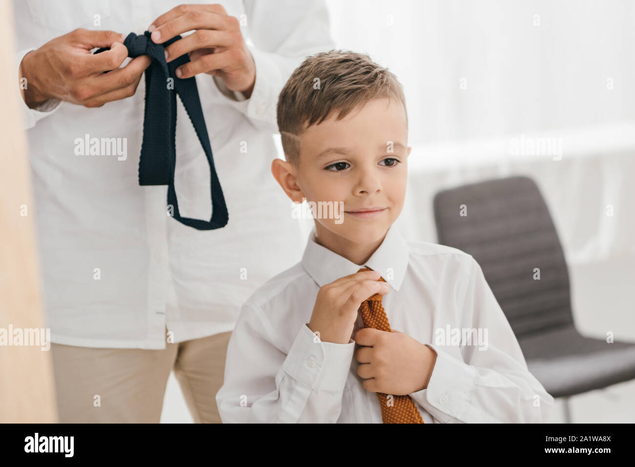 partial view of dad and son in white shirts with ties Stock Photo - Alamy