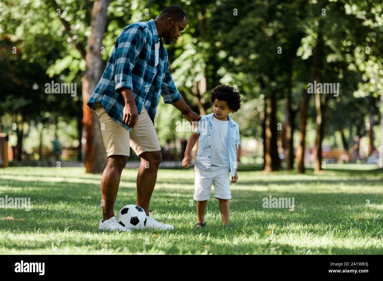 Handsome father son playing soccer hi-res stock photography and images ...