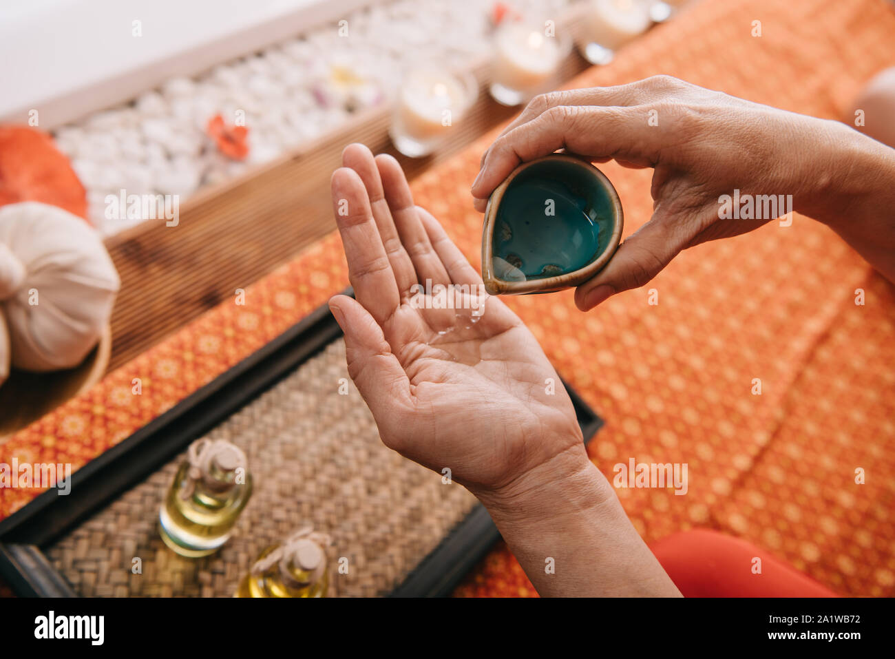 Woman pouring oil on hands hi-res stock photography and images - Alamy
