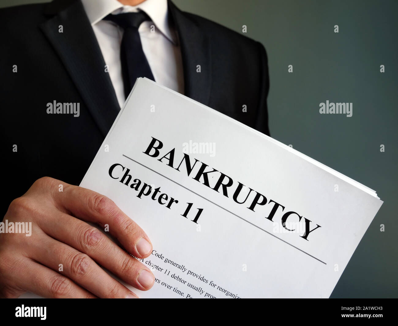 Man holds Bankruptcy Chapter 11 agreement documents Stock Photo - Alamy