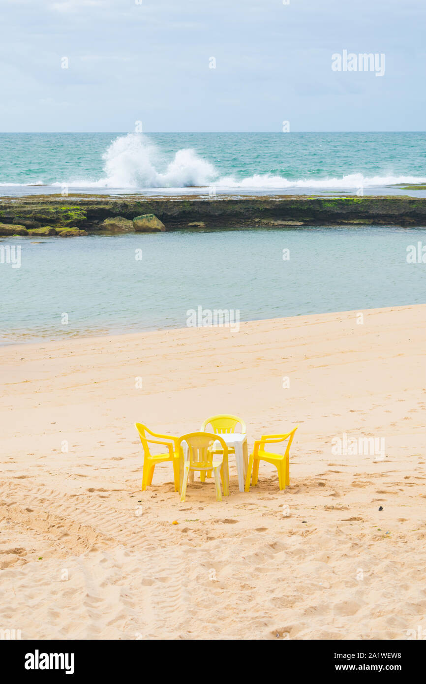 Bar table and chairs and natural swimming pool in the background at the ...