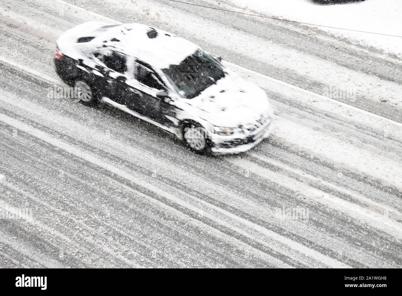 Blurry driving car on the empty city street during a snowfall Stock ...