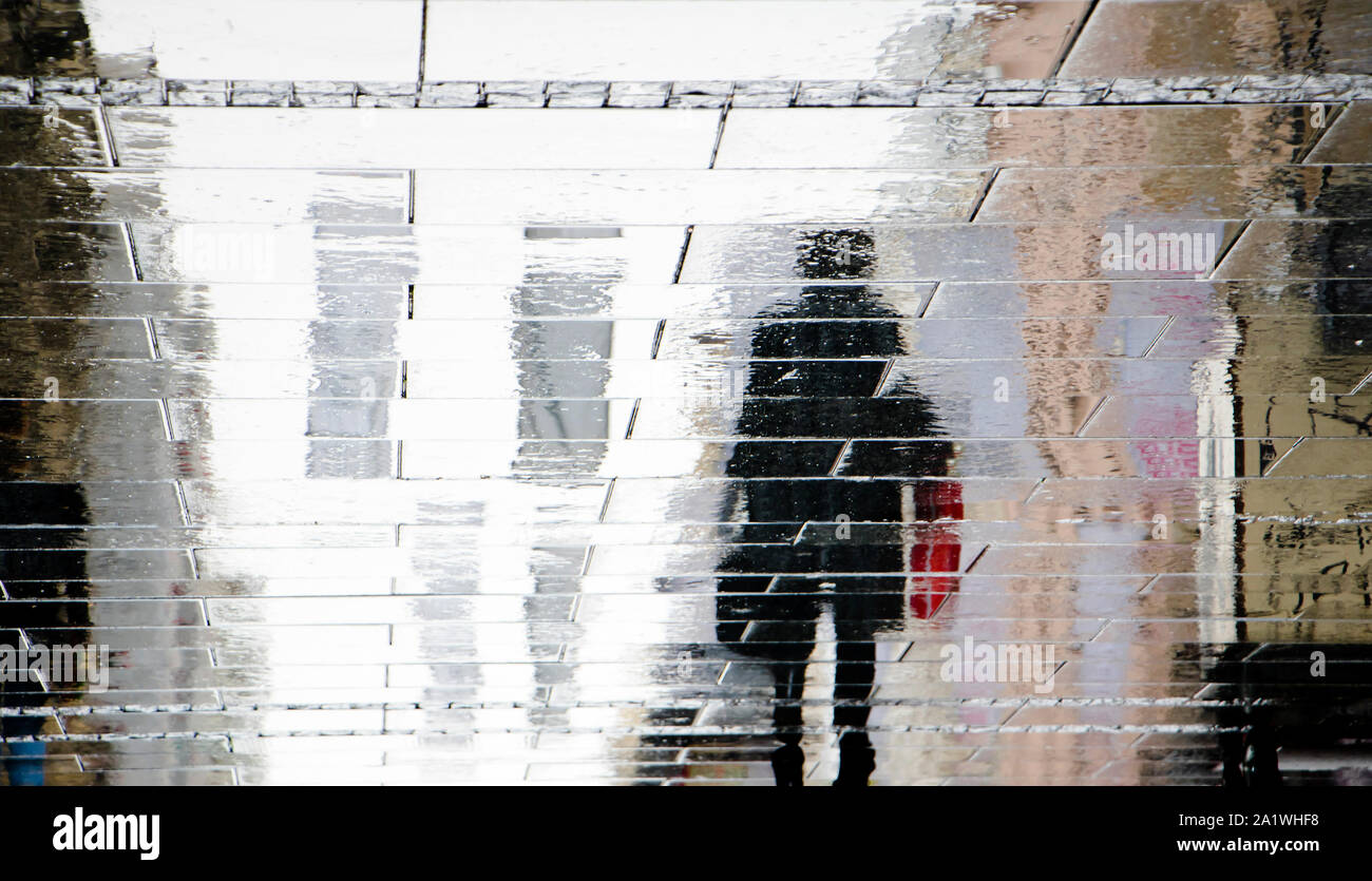 People puddle reflection in festival hi-res stock photography and ...