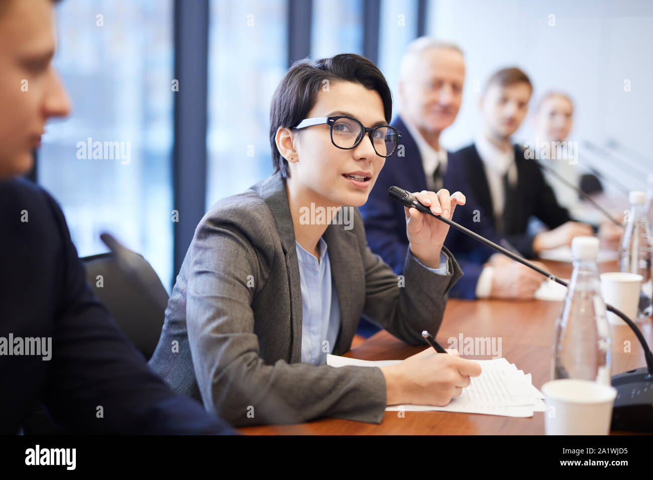 Sitting communication microphone leadership smiling hi-res stock ...