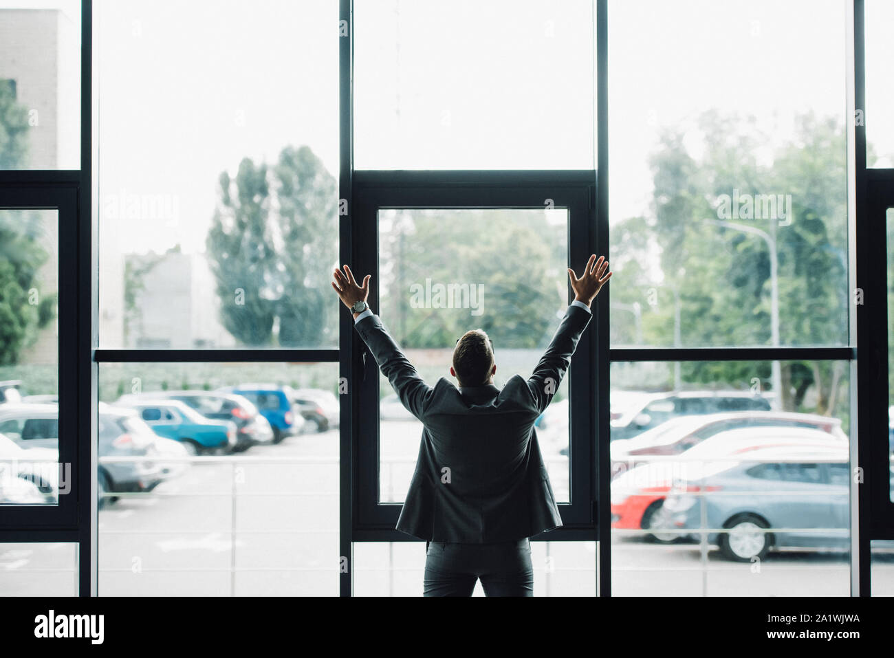 back view of man in formal wear outstretched hands Stock Photo - Alamy