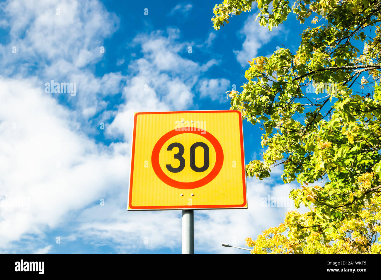Finnish speed limit sign 30 km h on blue sky background Stock Photo - Alamy